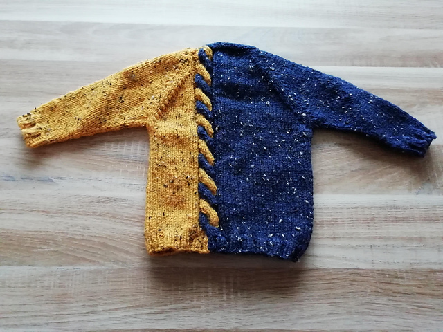 Ravelry: StrandsOfRNee's Two-color cable baby sweater