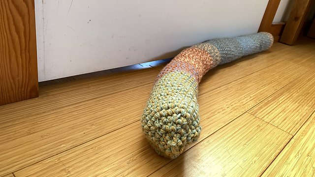 Ravelry: Draft Blocker pattern by Michael Sellick