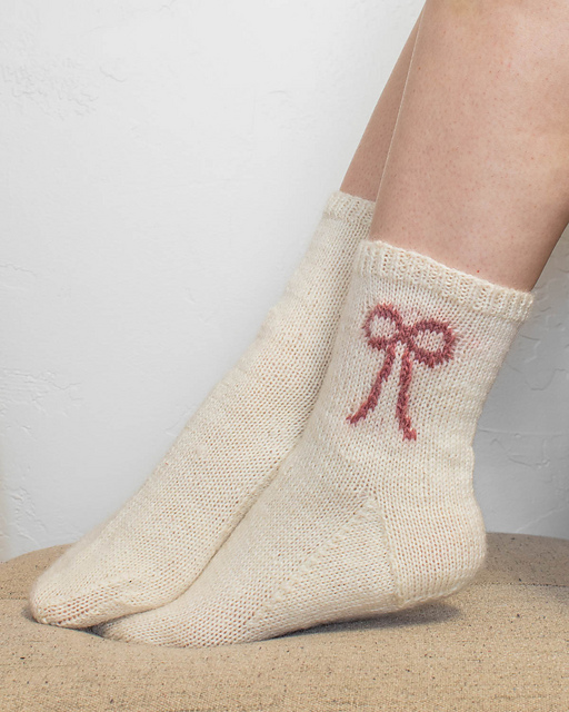 Ravelry: Adelia Bow Socks pattern by Emma Yochim
