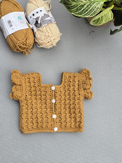 Ravelry: Toasted Marshmallow Baby Top pattern by Susanna Biaye