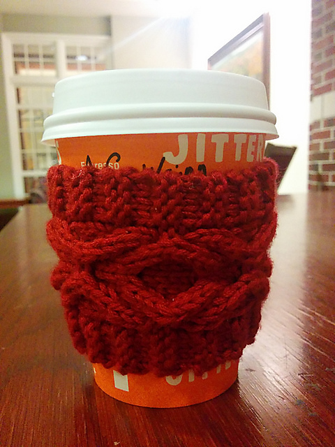 Ravelry: XOXO Cabled Coffee Cozy pattern by Julia Tallant